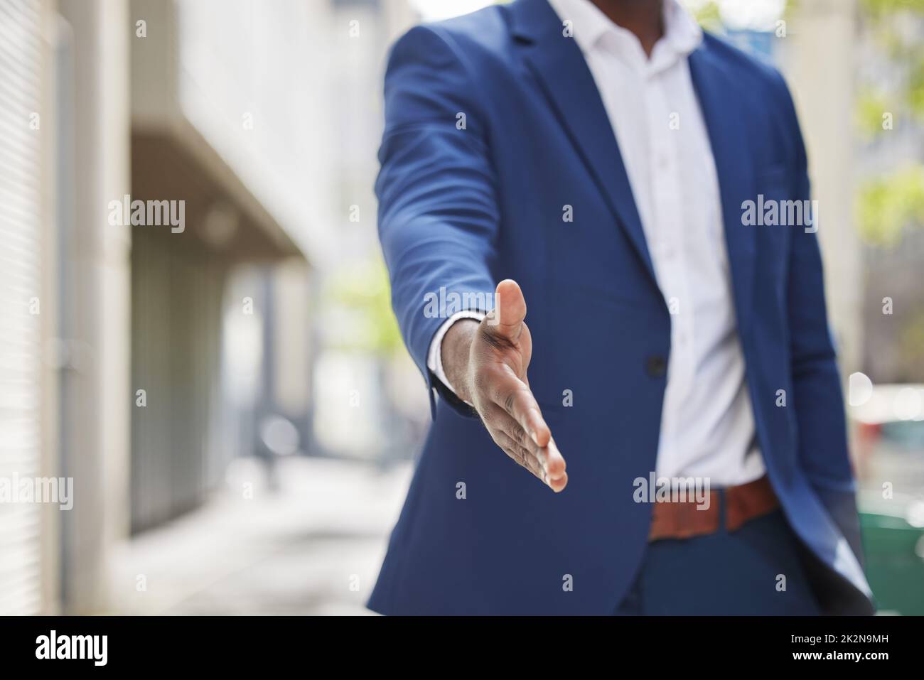 Businessman holding hand out handshake hi-res stock photography and ...