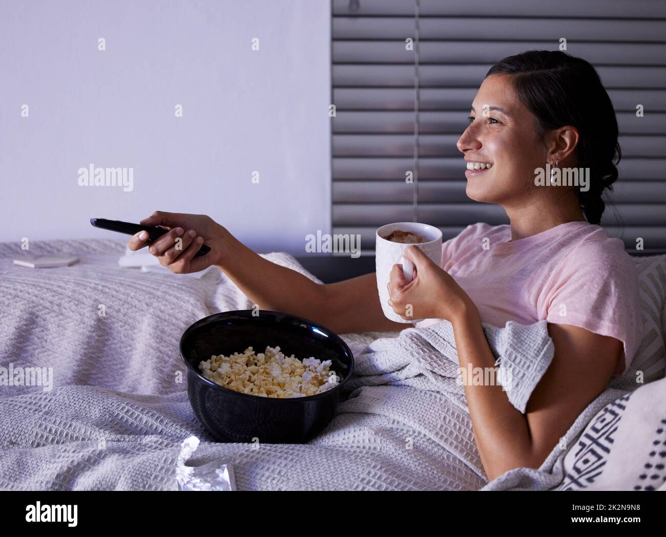 Woman alone watching movie in tv hi-res stock photography and images ...