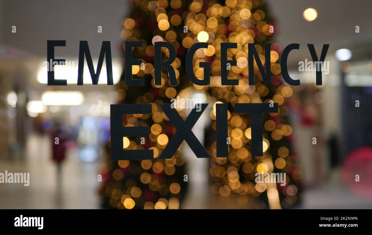 Emergency exit sign on empty city mall during pandemic Stock Photo - Alamy