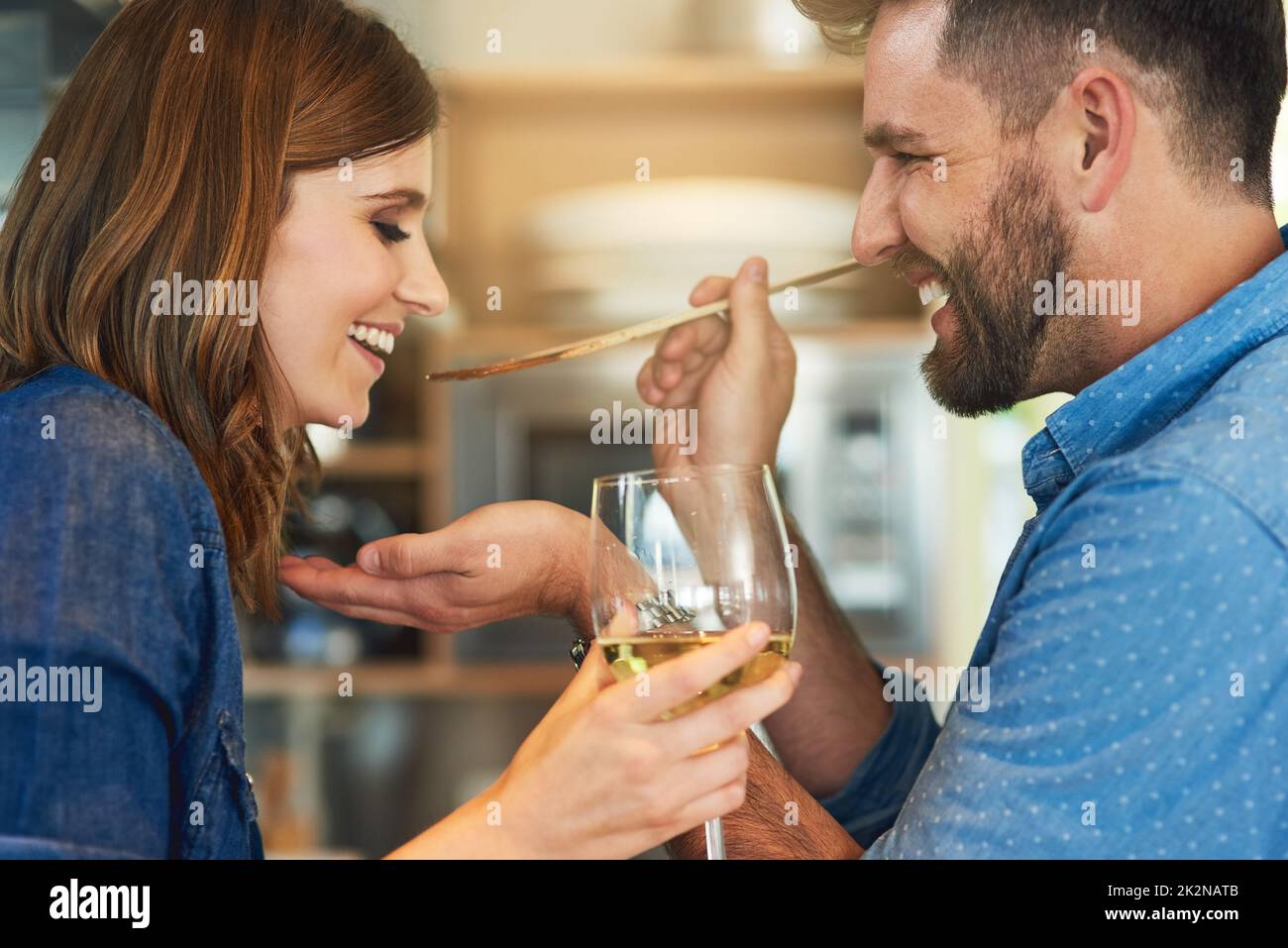Good food and good loving. Shot of a man giving his wife a taste of the ...