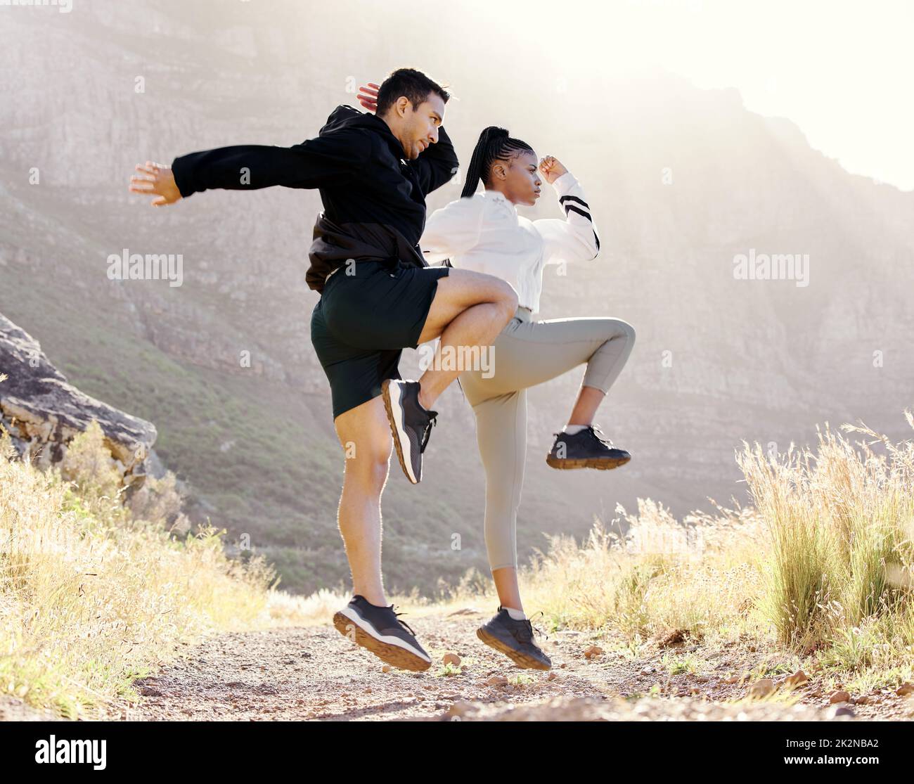 Couple exercise fitness in Los Angeles park, jump stretching body and ...
