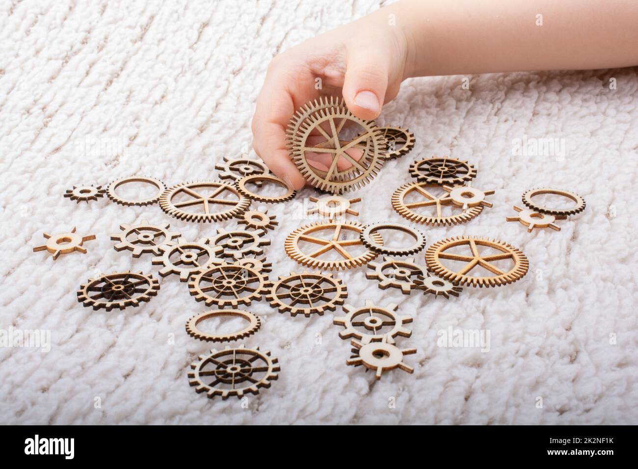 Hand holding gear wheels as the concept of mechanism Stock Photo - Alamy