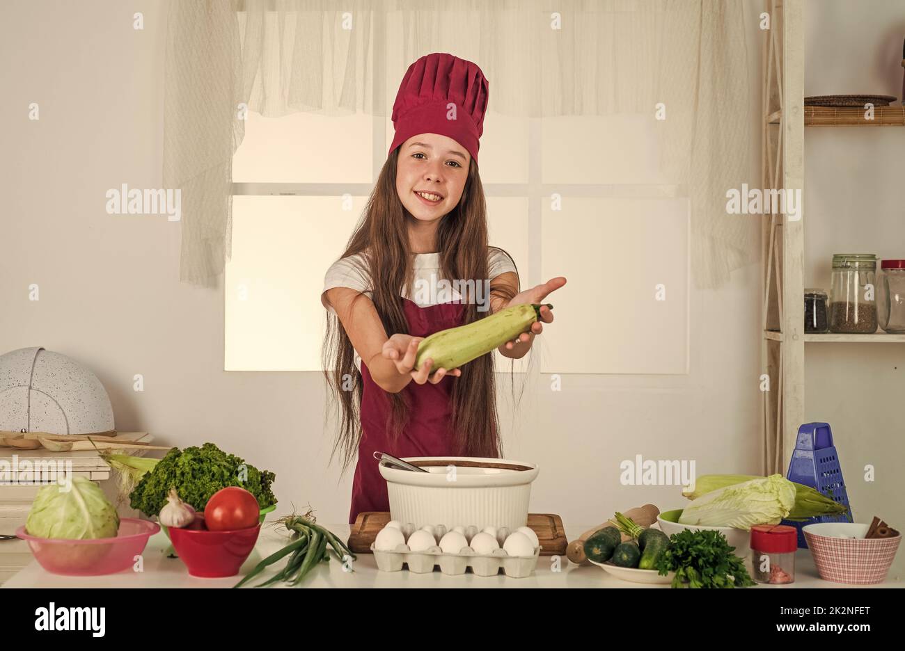 kid cooking food in kitchen. choosing a career. little helper with ...
