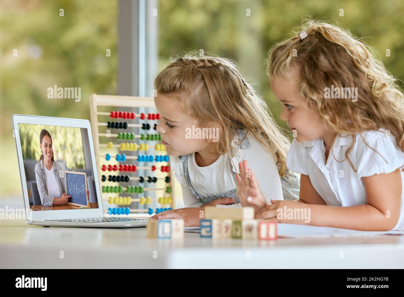 Laptop, learning and education with a girl and her twin sister in ...
