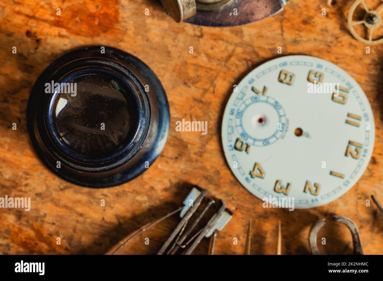 Top down view on a Jewellers Loupe and clock dial Stock Photo - Alamy