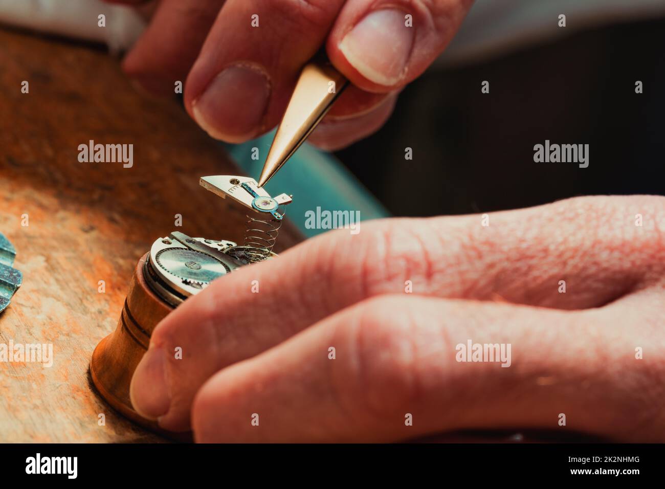 Watchmaker working with the spring mechanism of an old watch Stock ...