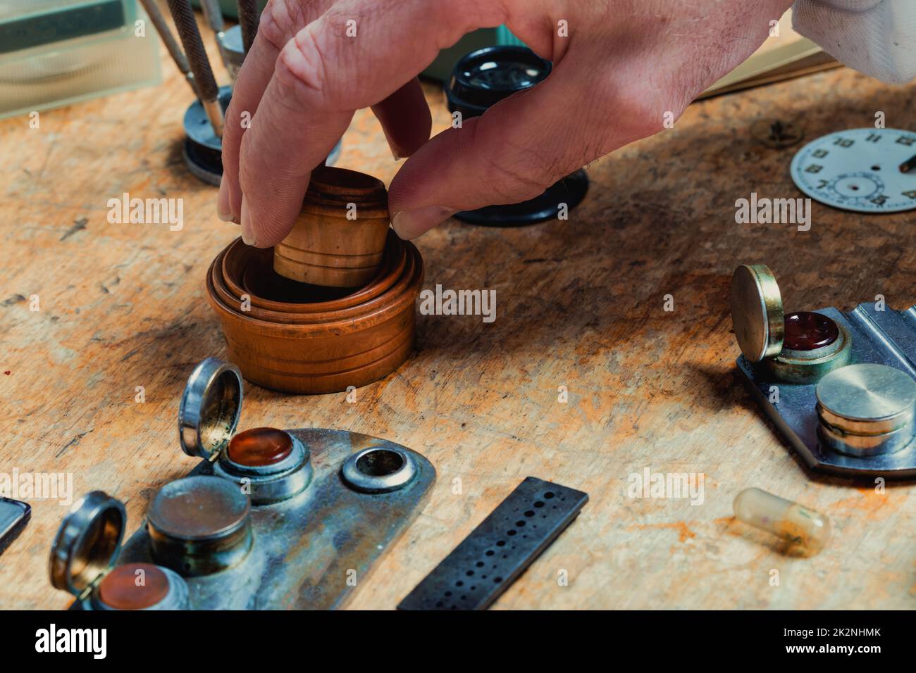 Male hand reaching for a tool on a watchmakers workbench Stock Photo ...