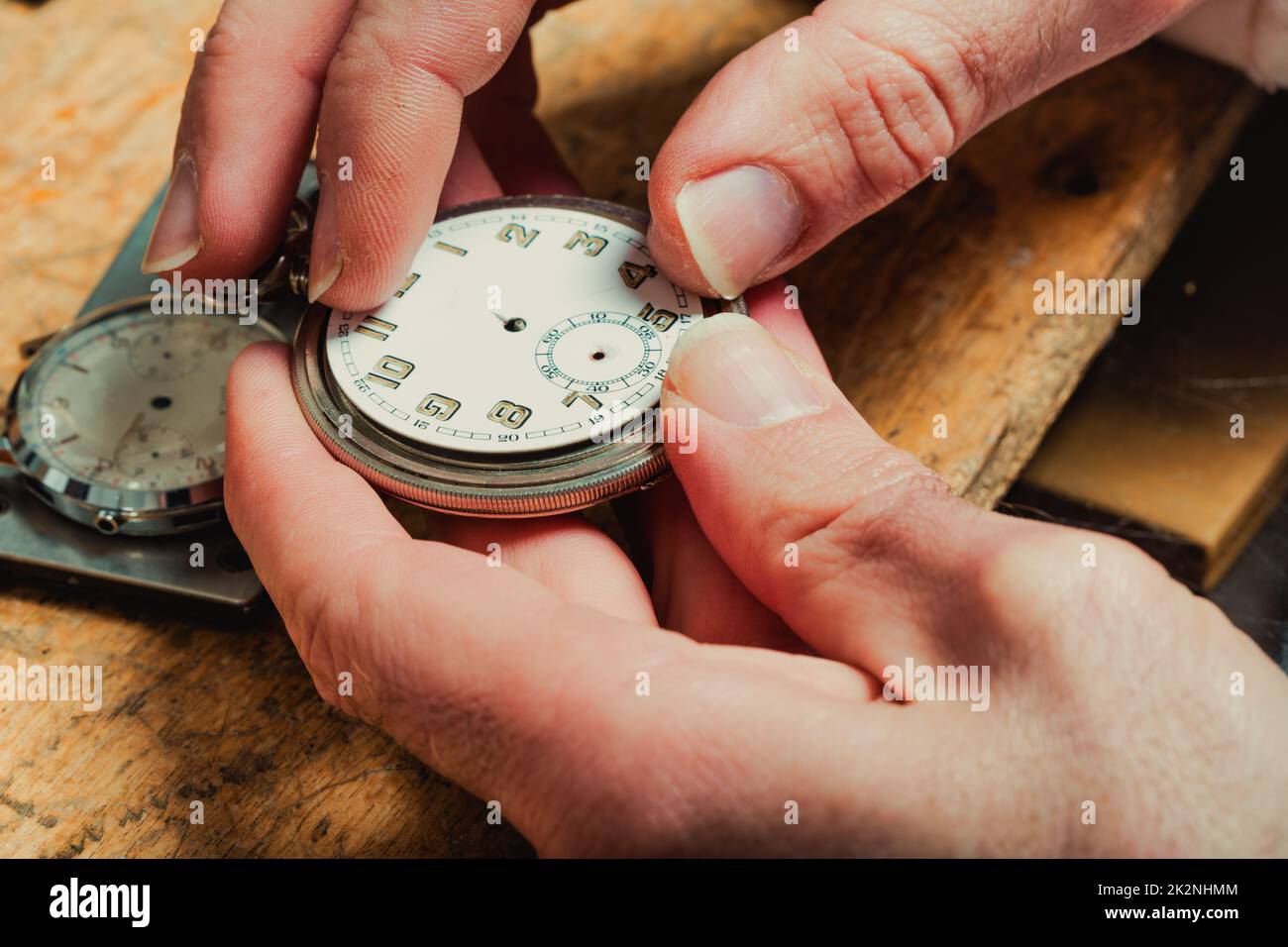 Watchmaker replacing the dial on an old watch Stock Photo - Alamy
