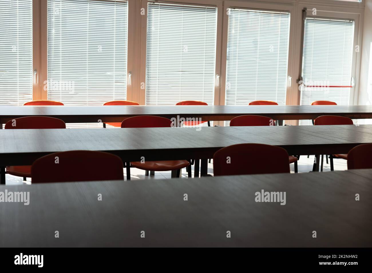 Empty desks and chairs in abandoned office room Stock Photo - Alamy