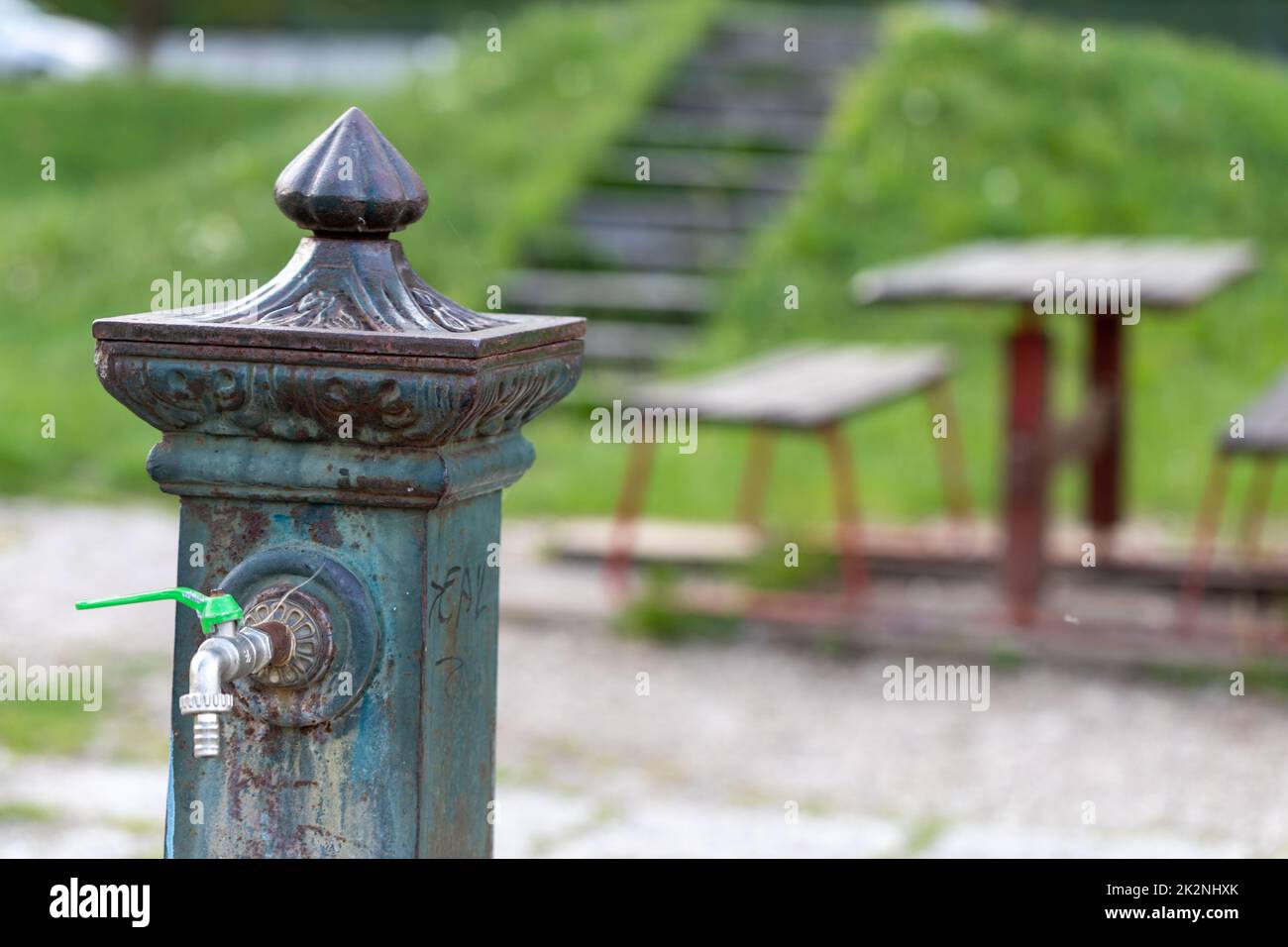 Old cast iron water fountain and empty tables Stock Photo - Alamy