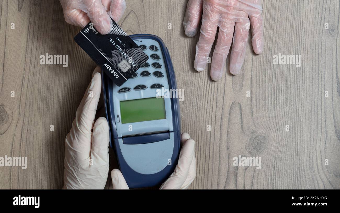 Shopper making a contactless payment at a shop Stock Photo - Alamy