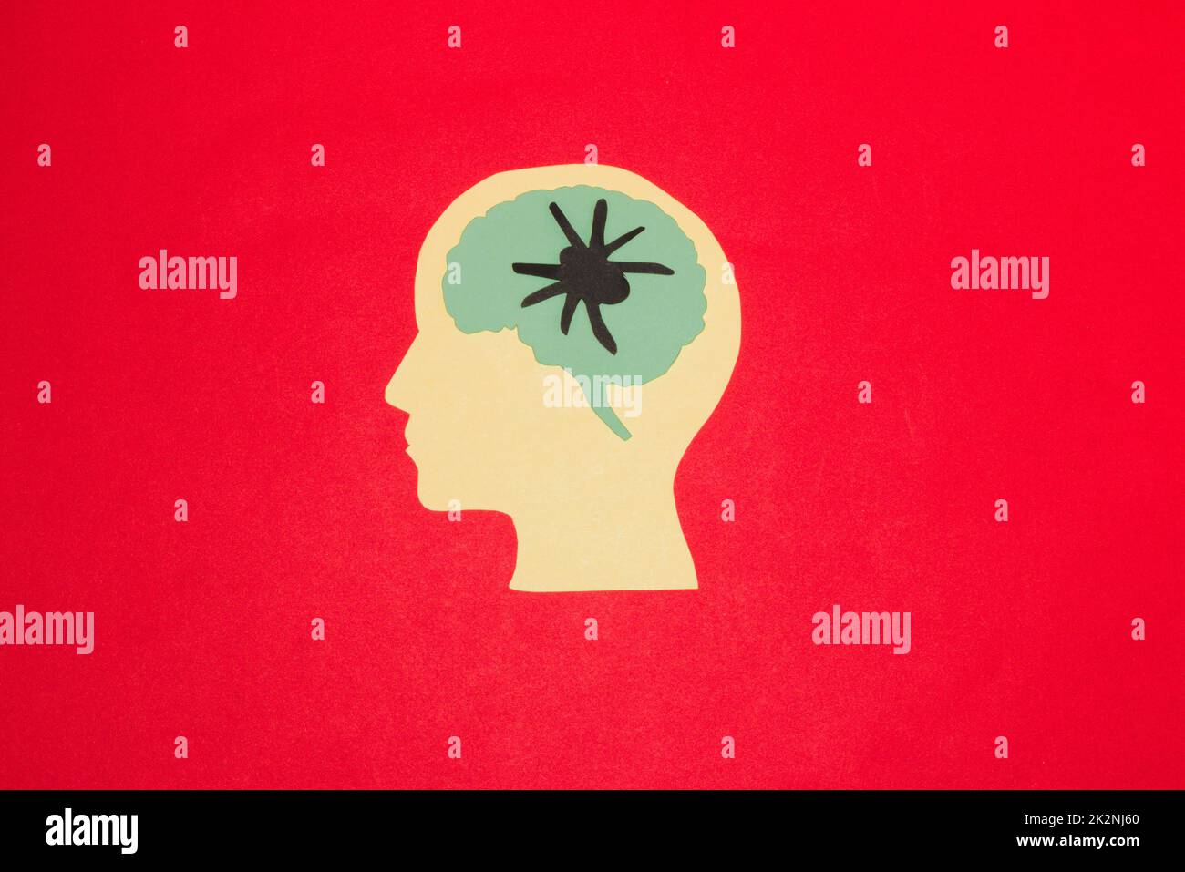 paper head with a brain in which there is a spider, creative halloween ...