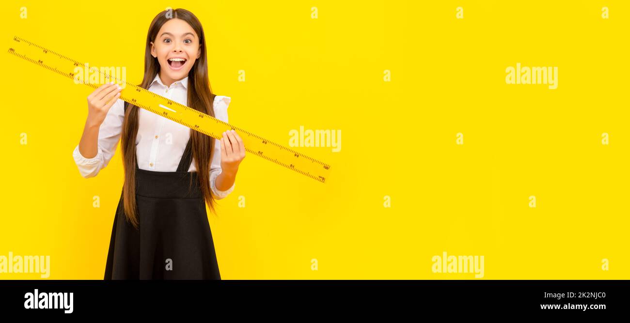 amazed kid in school uniform hold mathematics ruler for measuring ...