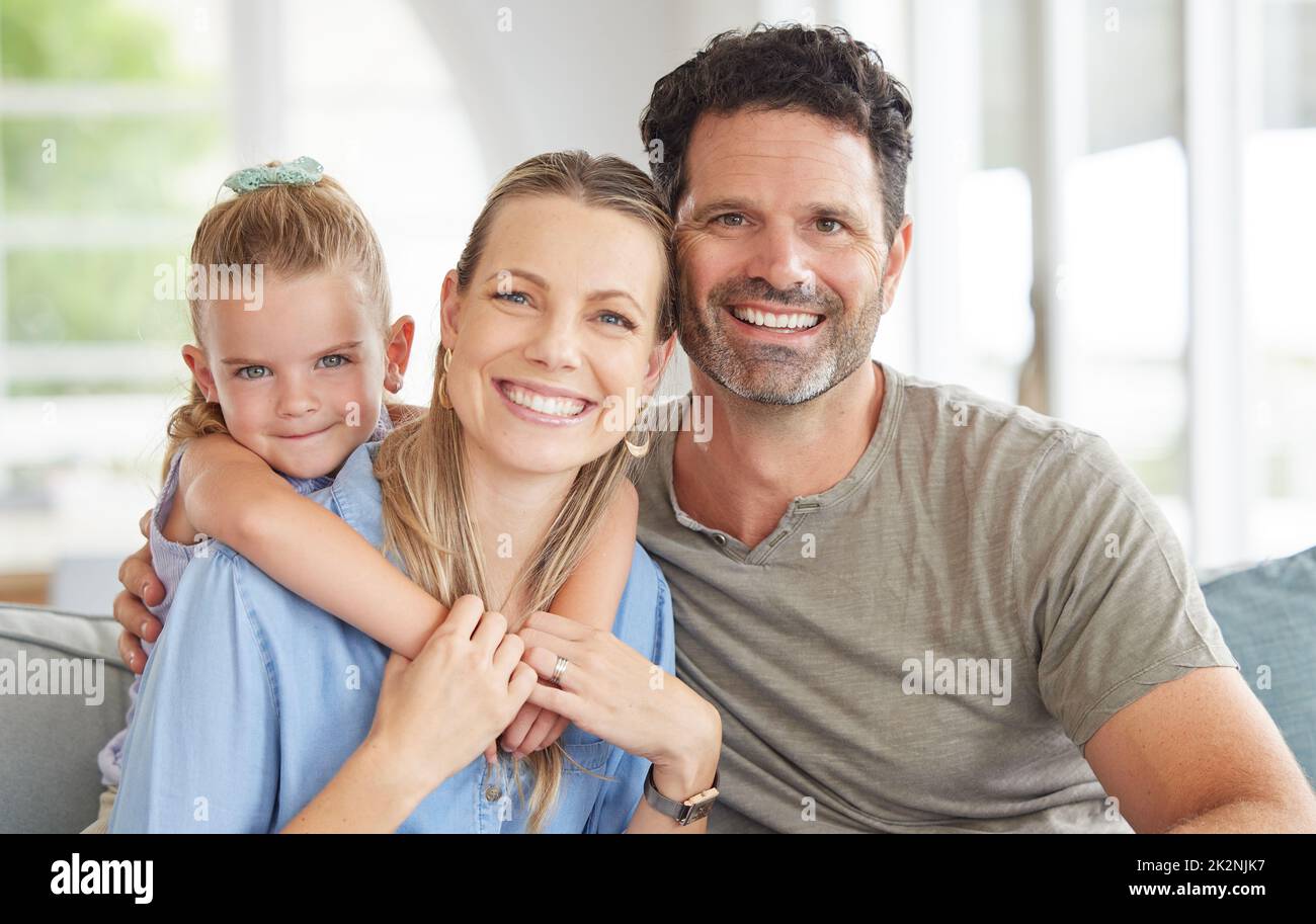 Children, family and love with a girl and her parents on a sofa in the ...