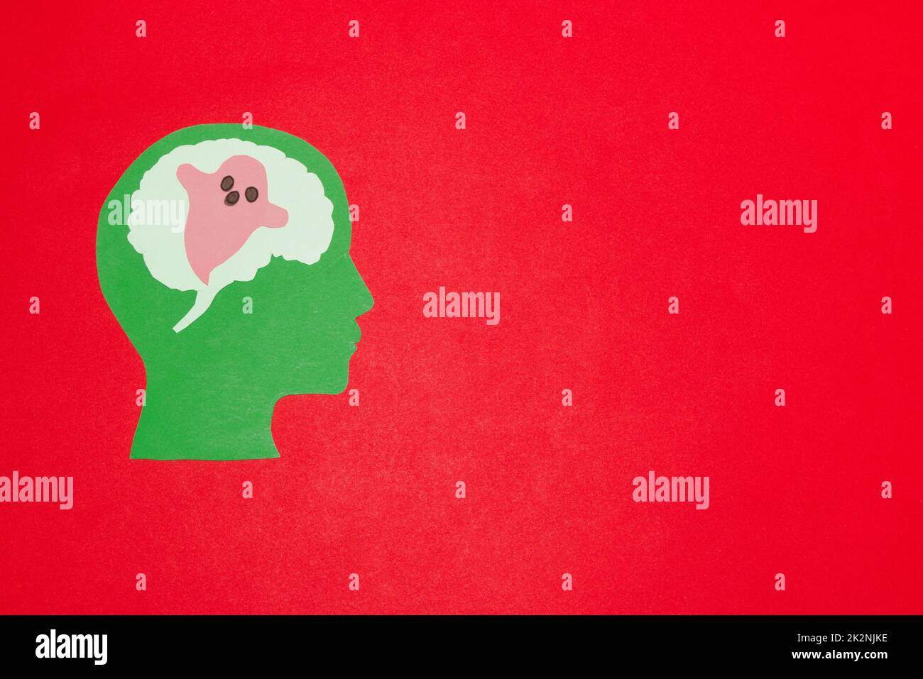 green paper head with a brain in which there is a ghost, creative ...