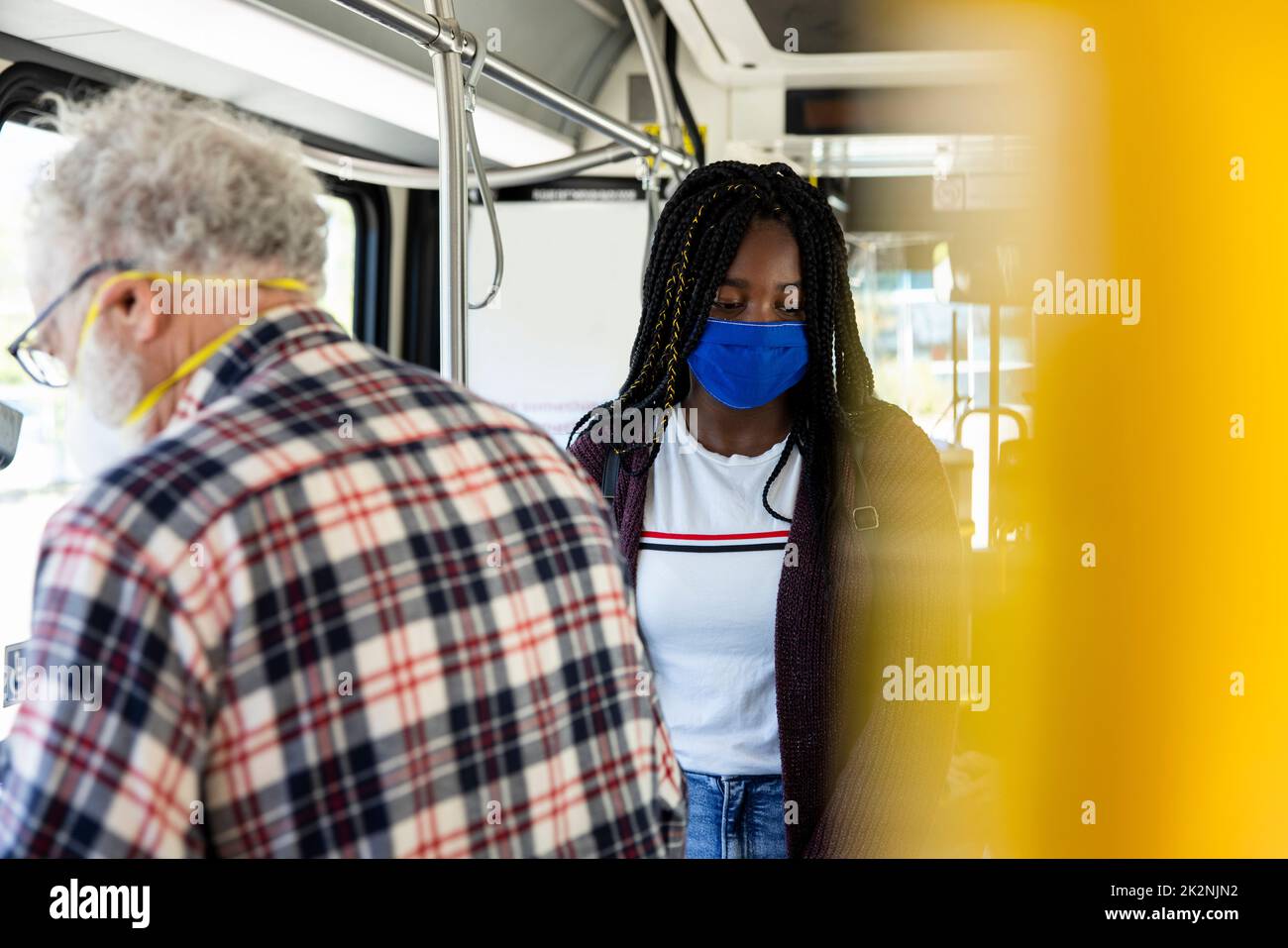 Female passenger in face mask boarding public bus Stock Photo - Alamy
