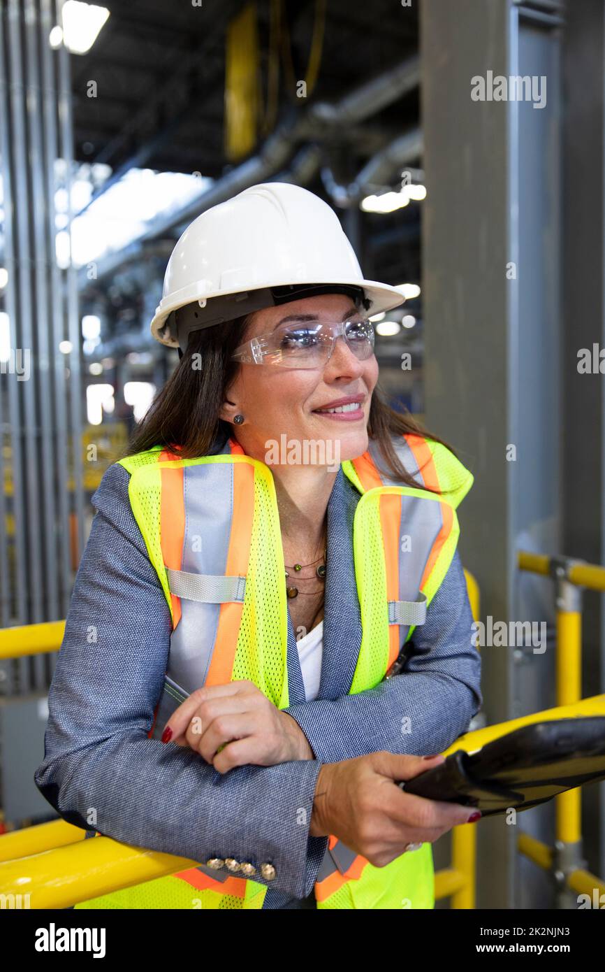 Confident female transit manager in hard hat Stock Photo - Alamy