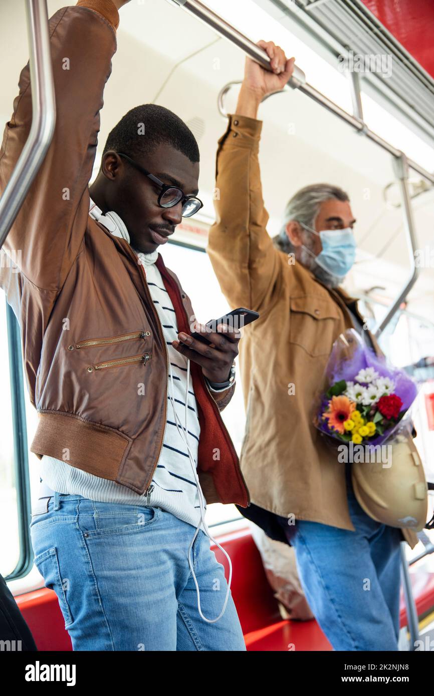 Holding handle subway hi-res stock photography and images - Alamy