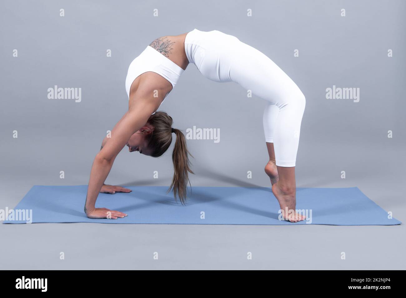 Girl stretching, doing bridge pose. Sportive girl, during exercises on ...