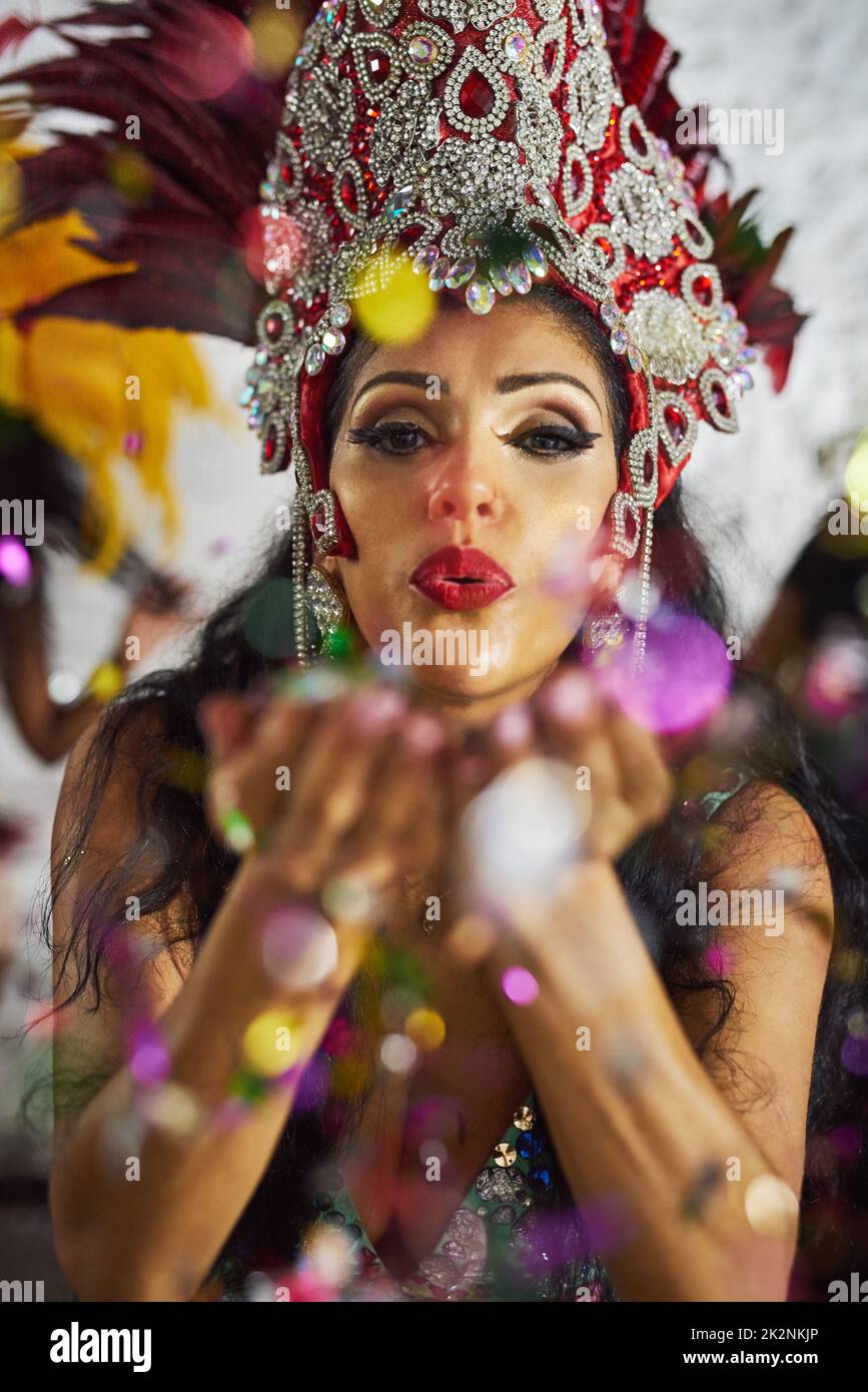 Making The Night Come Alive Shot Of A Samba Dancer Blowing Confetti