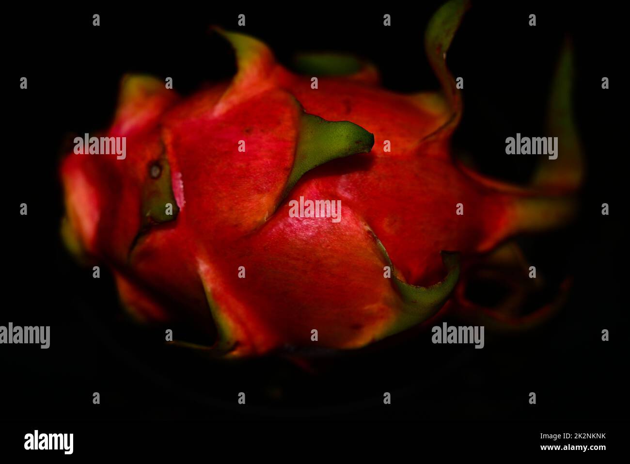 A closeup of red pitahaya in black background Stock Photo - Alamy