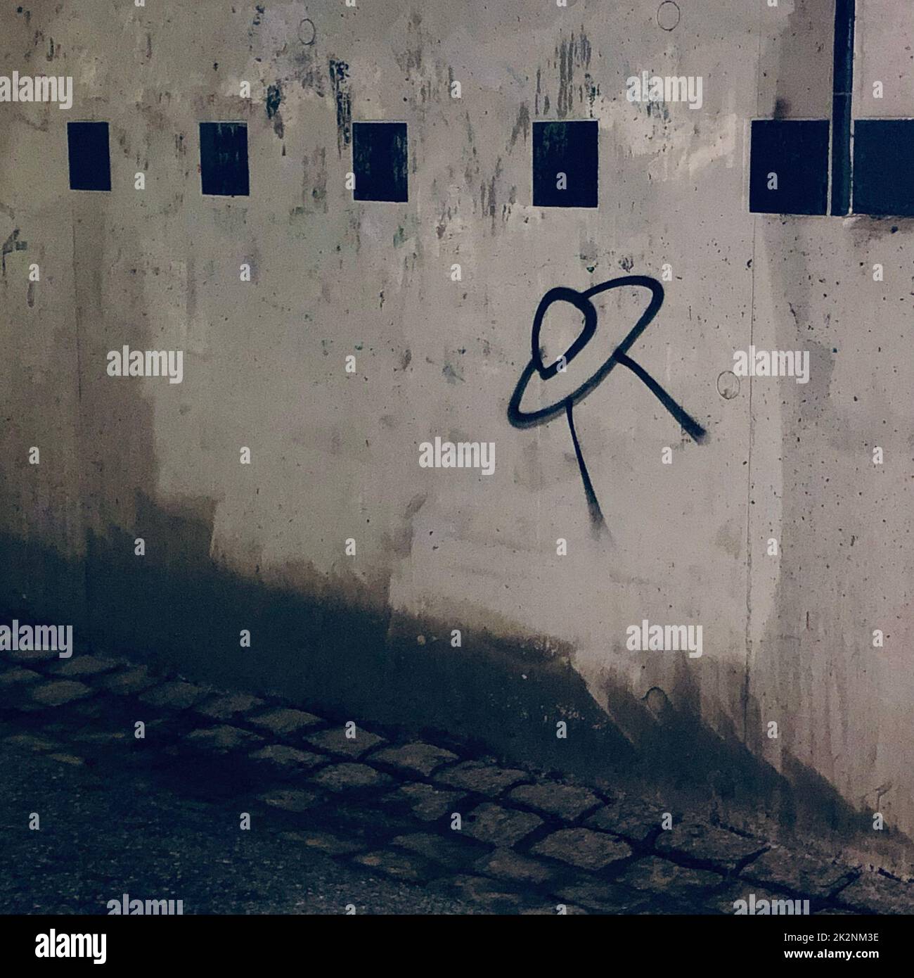 A black UFO graffiti on a wall in the tunnel Stock Photo - Alamy