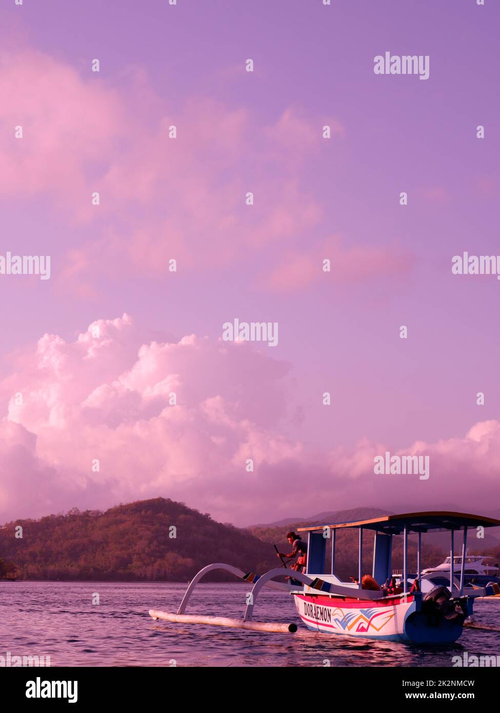 An aerial view of fisherman catching fish from boat floating in sea in ...