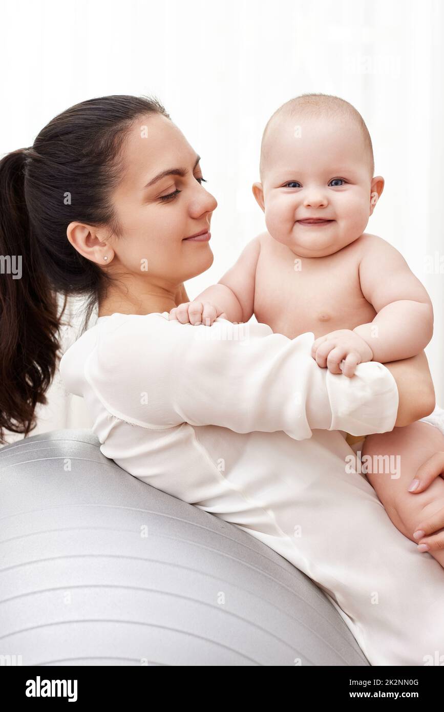 mother playing with her baby girl on a fitness ball Stock Photo - Alamy