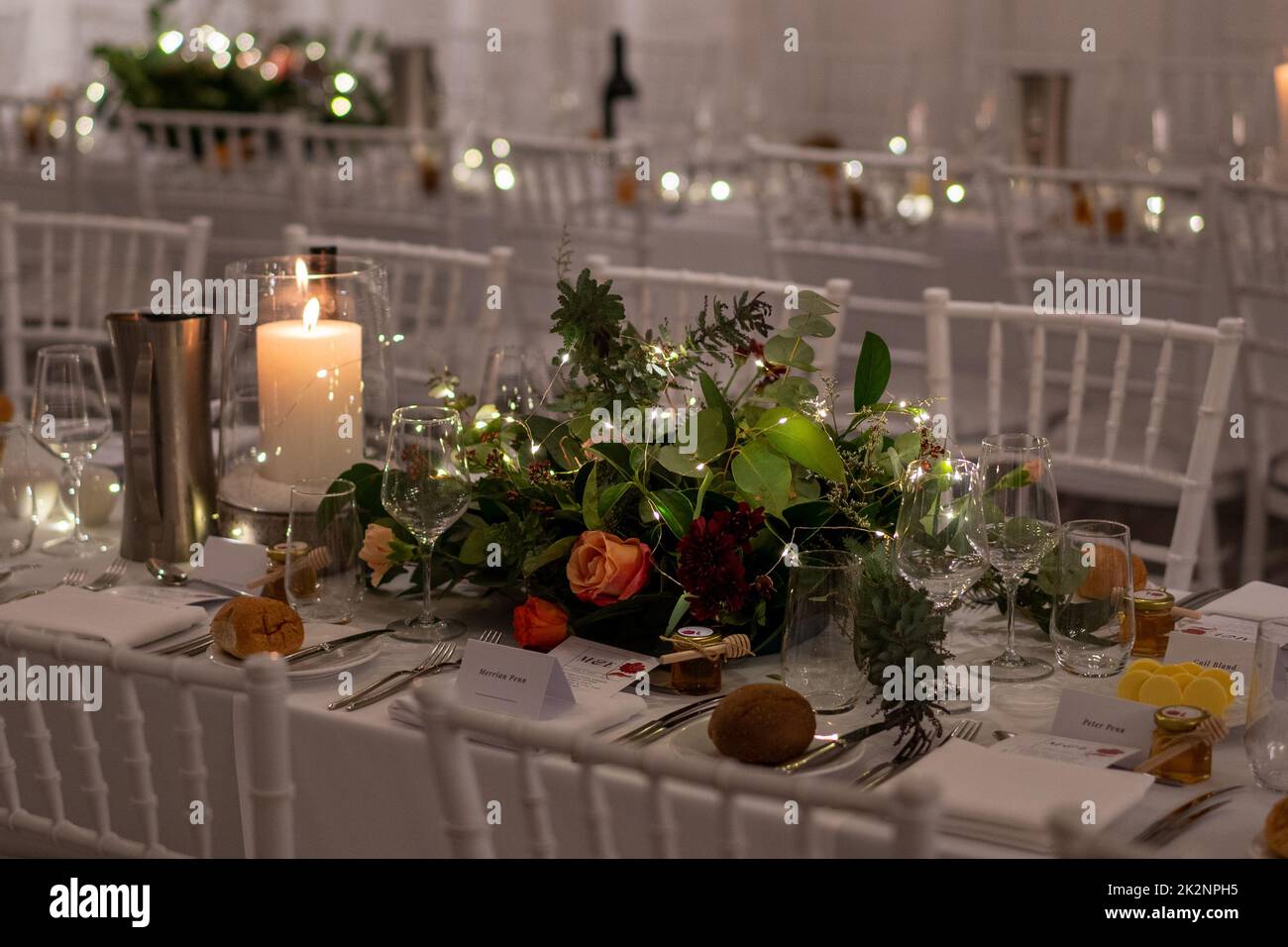 A closeup shot of an arranged wedding reception table with flowers ...