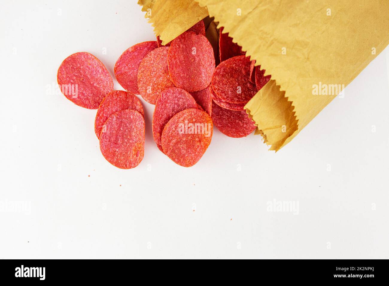 Selective focus. Macro chips in a craft bag. Spices and salt on red ...