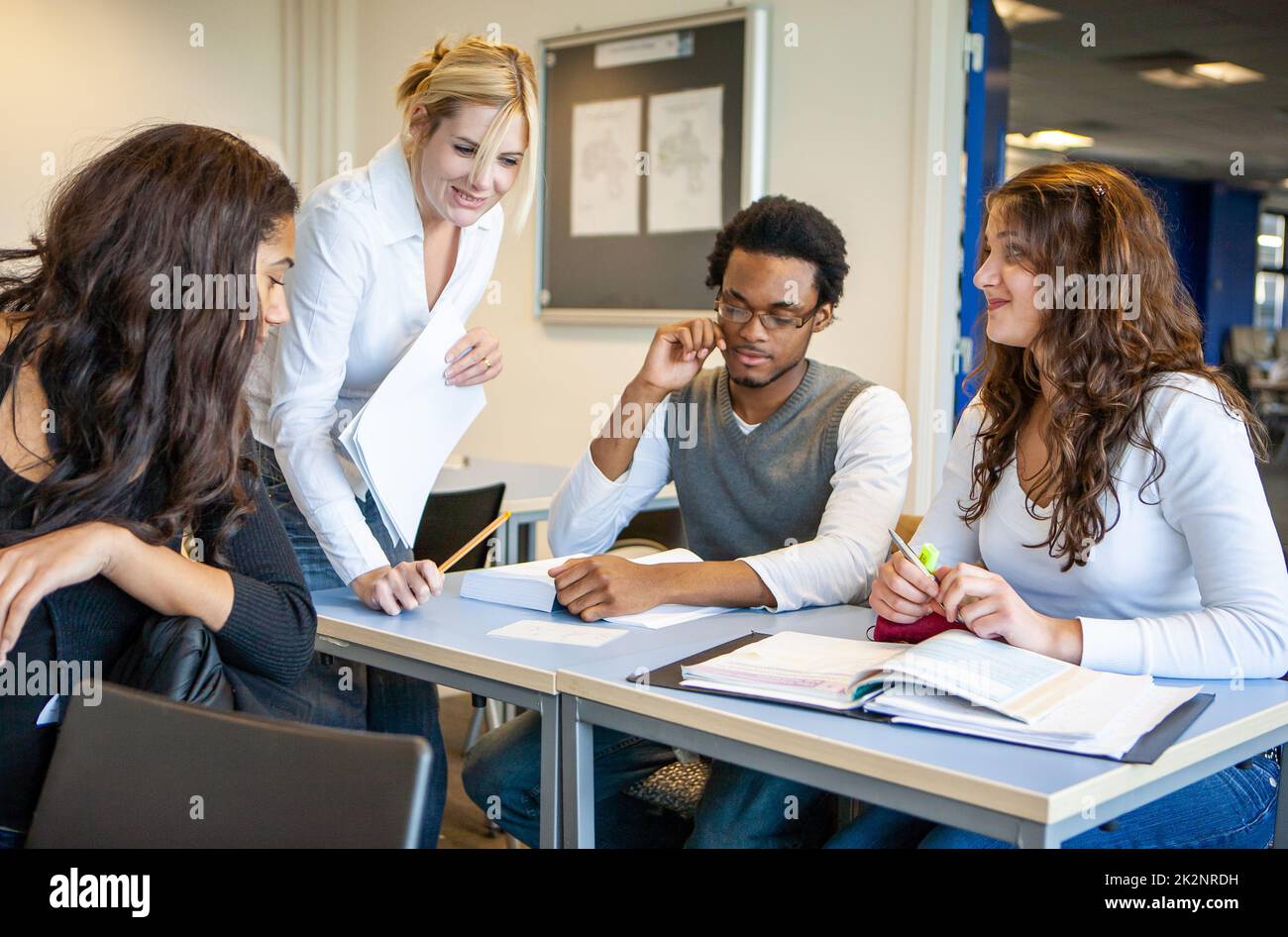 Female teacher teaching her students in a classroom hi-res stock ...
