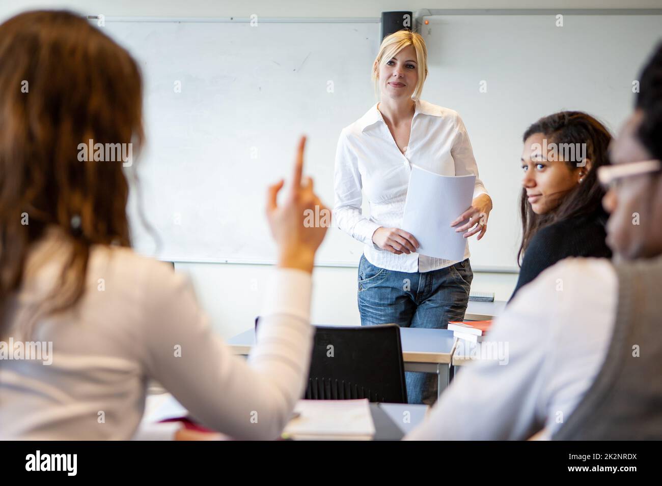Teenage Students: Raising a Point. A pupil asking a question for her ...