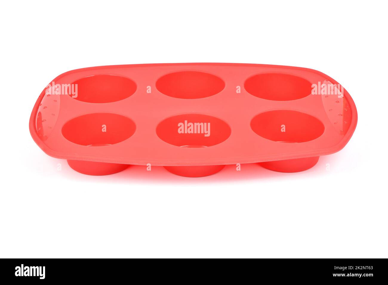 Red silicone form for cooking muffin and cupcake on white background ...