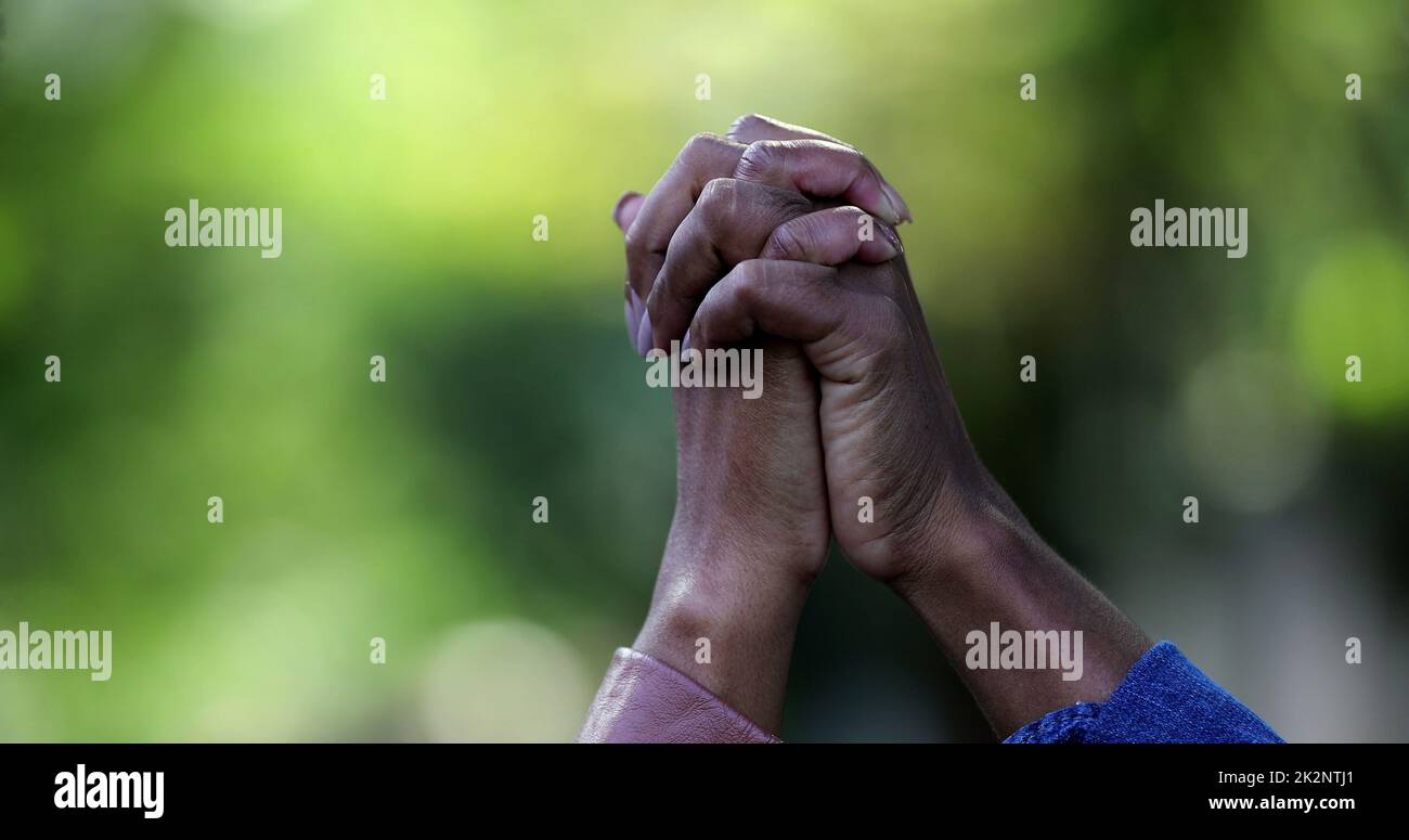 Two black hands joining together in unity Stock Photo - Alamy