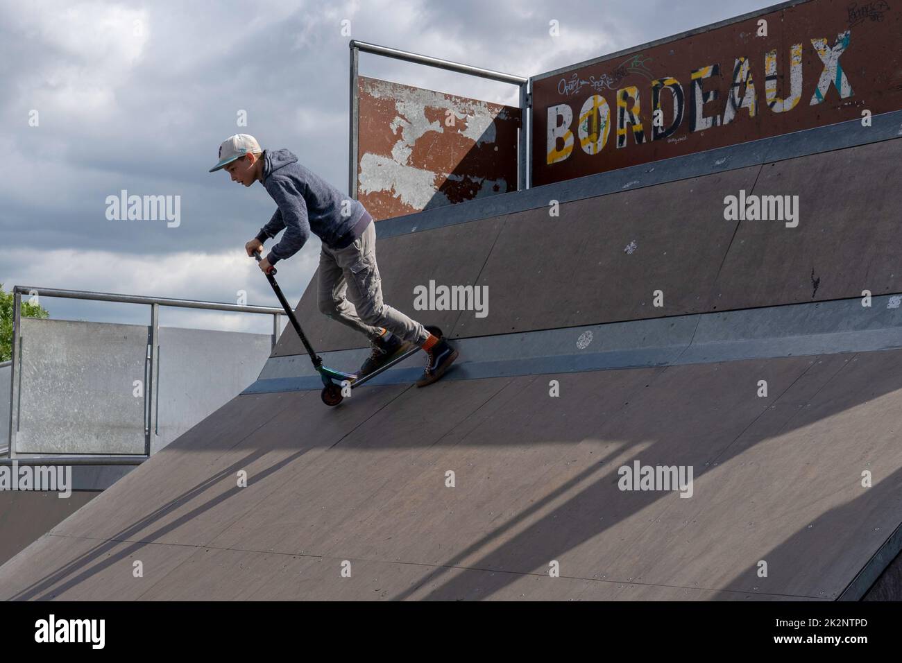 The young kid on scooters performing tricks on the ramp Stock Photo - Alamy