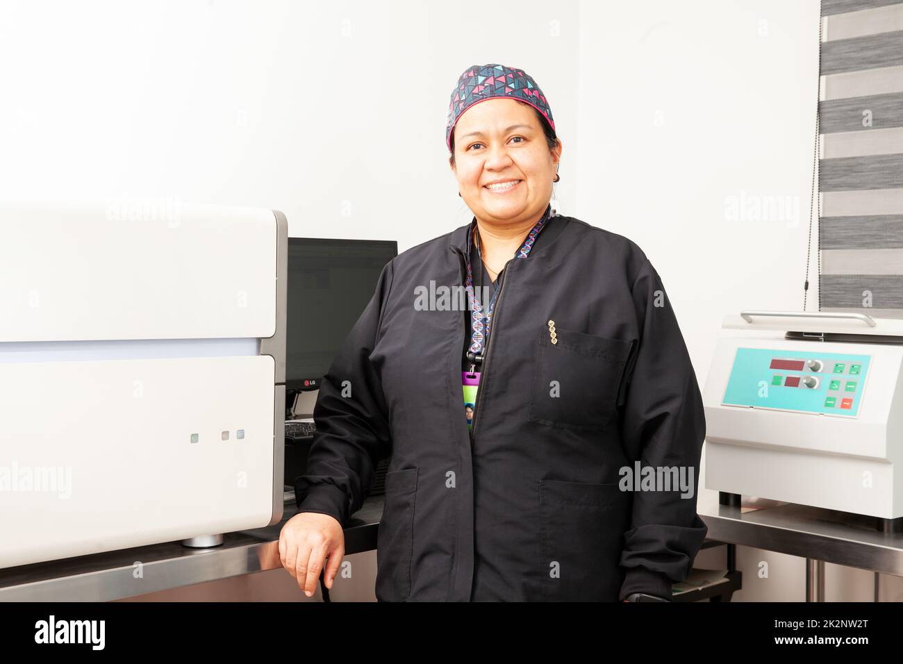 Female scientist working at the laboratory with a thermal cycler ...