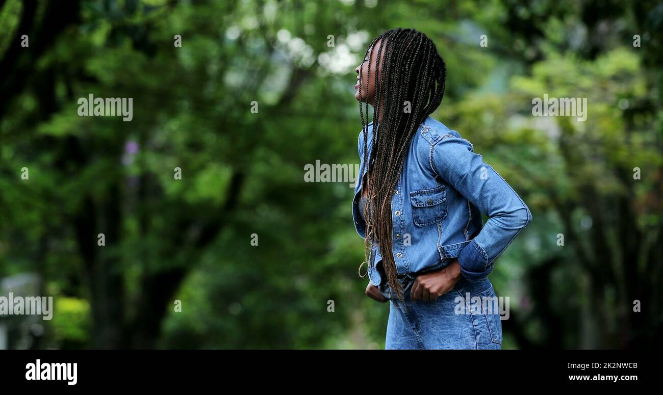 Woman adjusting pants and jacket. girl pulling pants up Stock Photo - Alamy