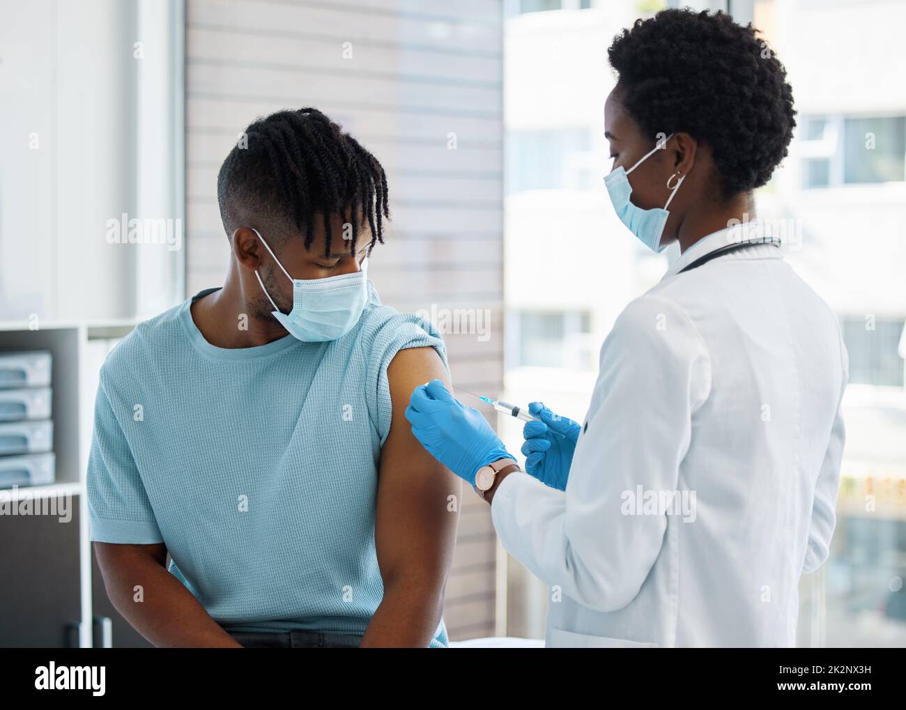 Doctor giving injection male patient hi-res stock photography and ...