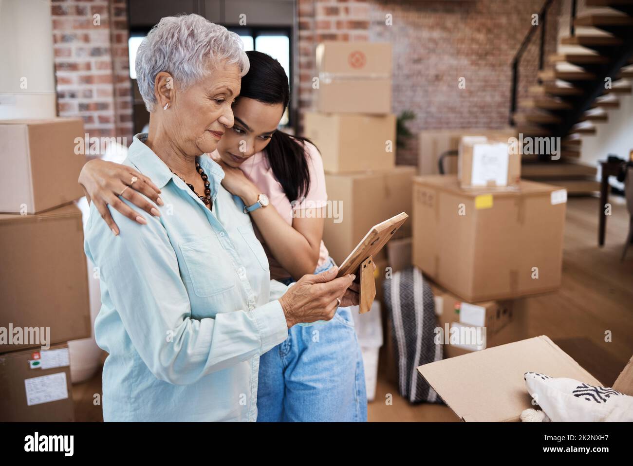 Sad woman packing boxes hi-res stock photography and images - Alamy