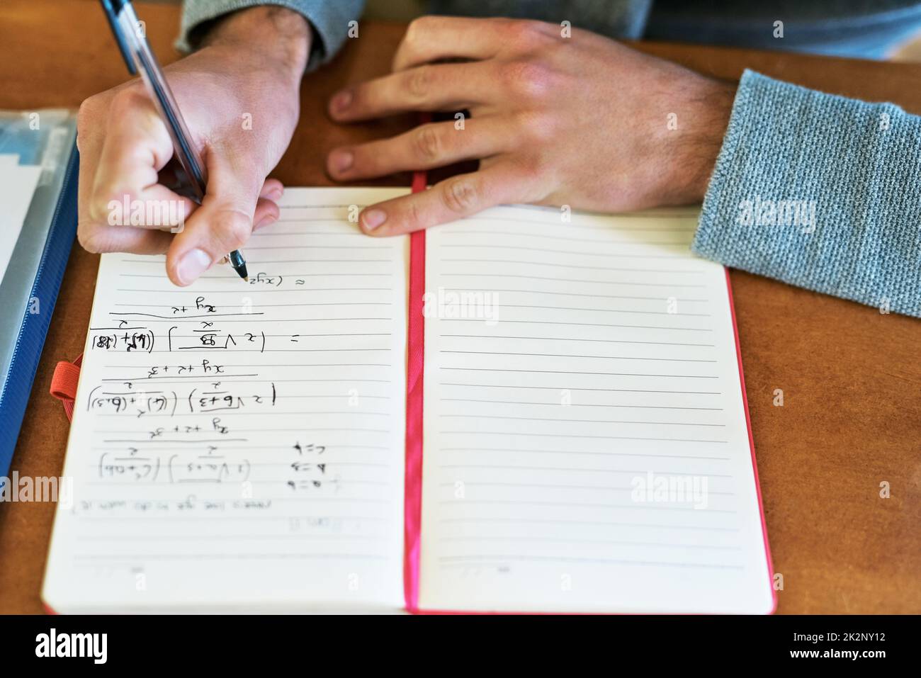 Working it out. High angle shot of an unrecognizable university student ...