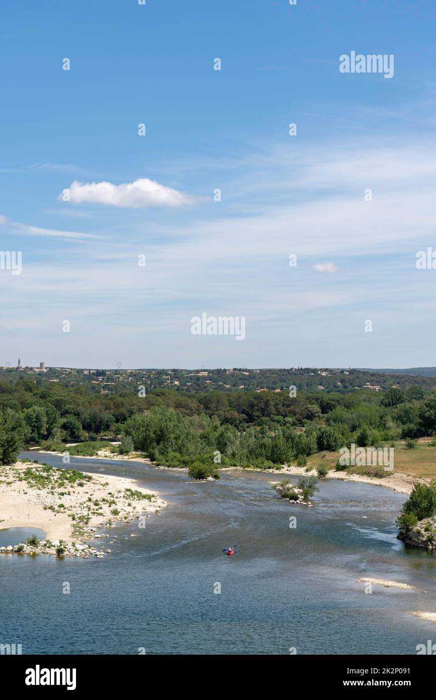 A vertical bird's-eye view of a boat in a river with the background of ...