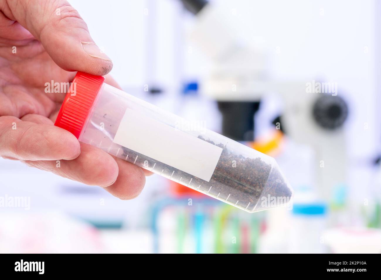 scientist ecologist holds a container with a soil sample for chemical ...