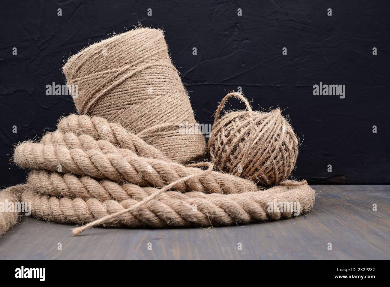 Jute rope and spools of burlap threads or twine Stock Photo - Alamy