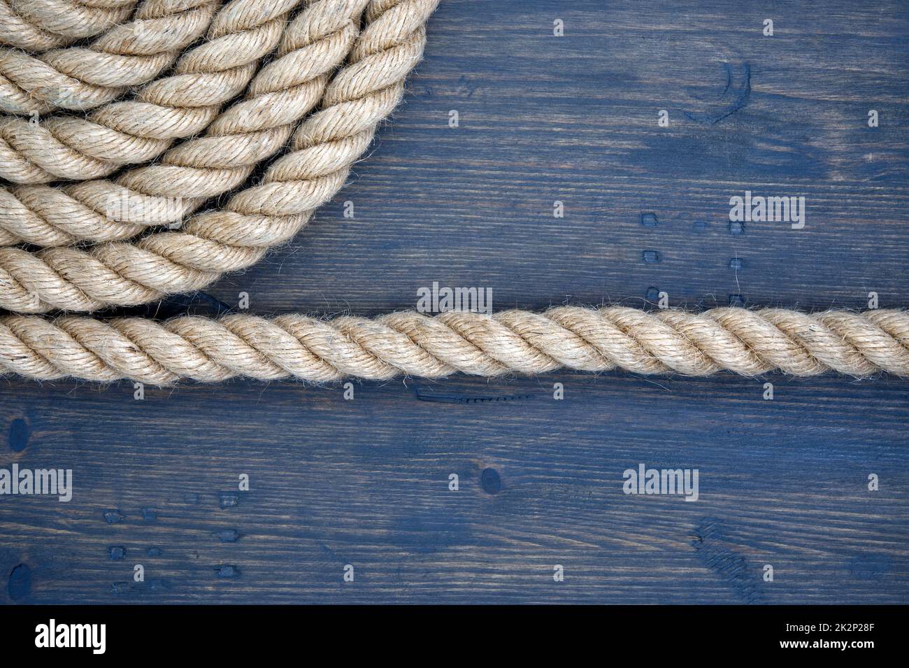 Braided natural jute rope over a rustic wood Stock Photo - Alamy
