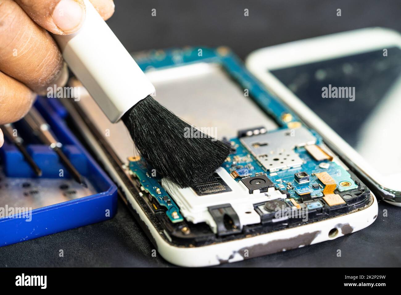 Technician use brush and air blower ball to clean dust in circuit board ...