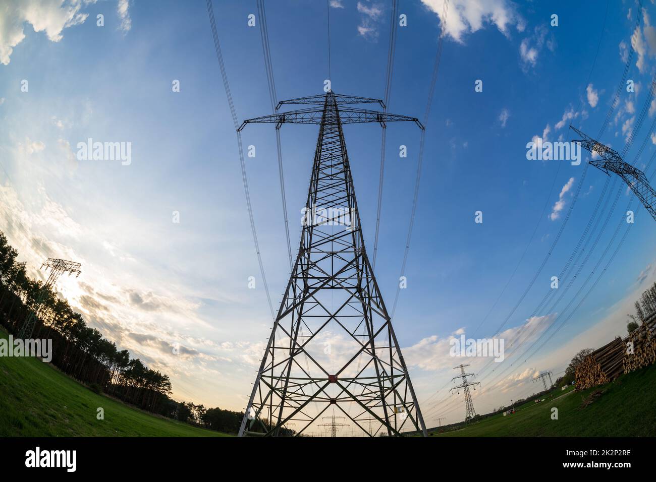Metal electricity transmission poles on a background of blue sky ...