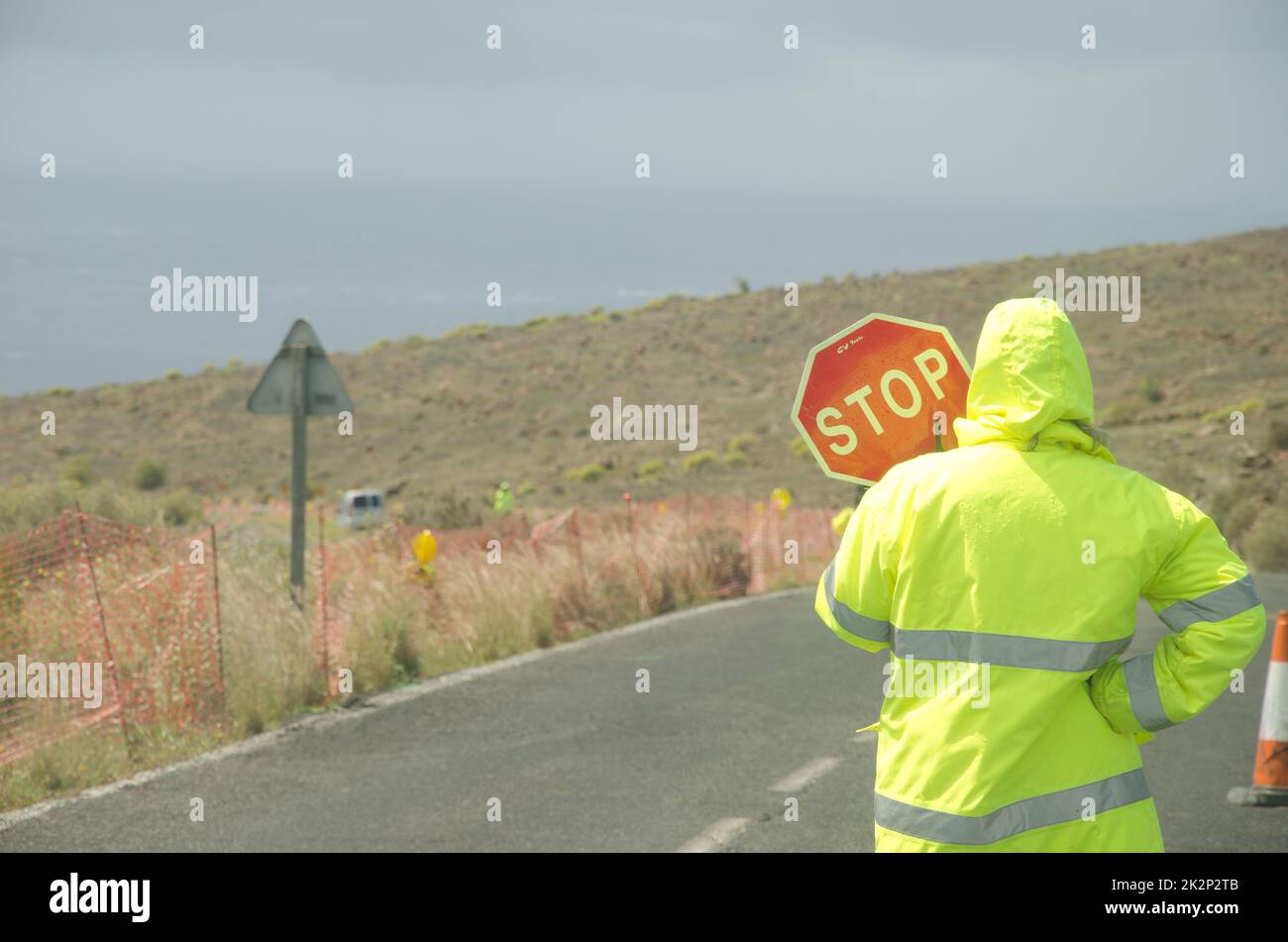 Woman holding a stop sign at a roadside traffic stop Stock Photo - Alamy