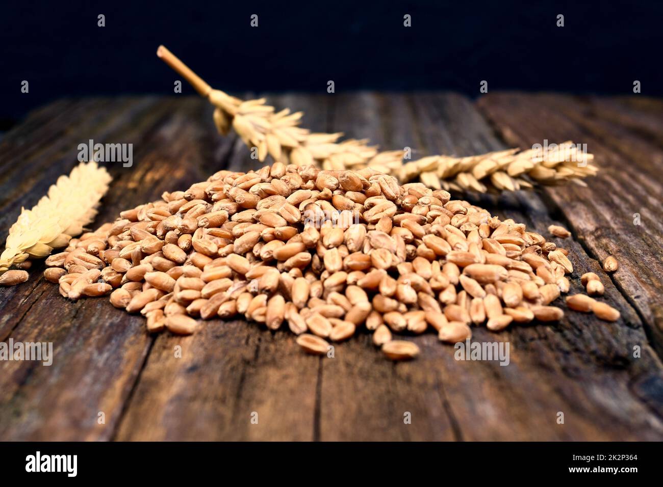 Pile of wheat grain on the rustic wooden table Stock Photo - Alamy