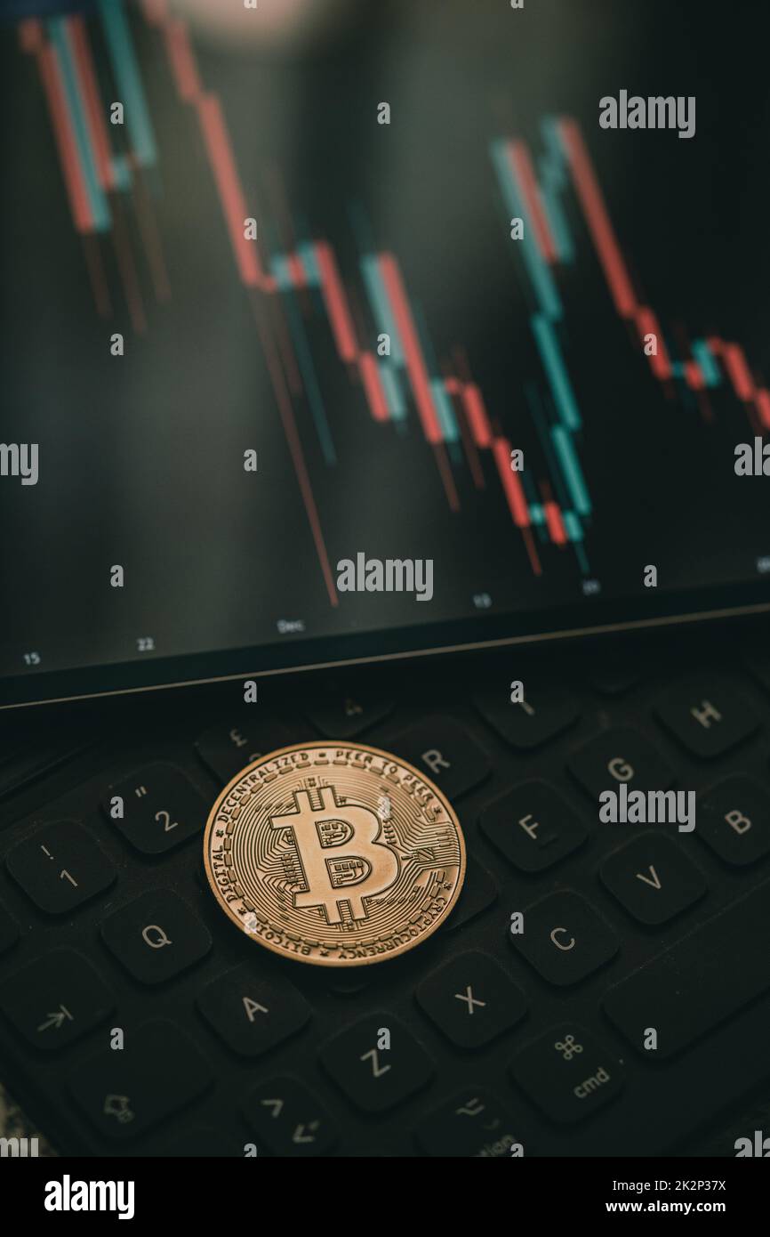 Bitcoin cryptocurrency with candle stick graph chart, laptop keyboard ...