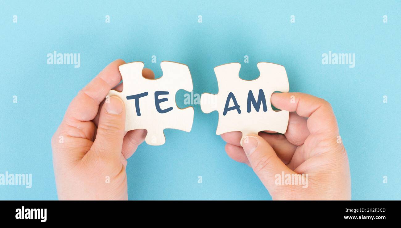The word team is standing on puzzle pieces, connect the parts together ...